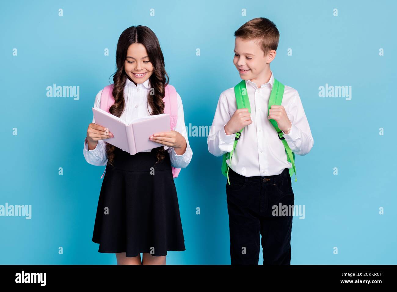 Photo of two little girl boy schoolkid best friends prepare homework ...