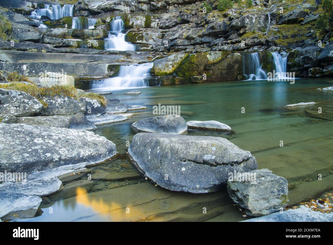 Beautiful low angle shot of waterfalls in the middle of the forest ...
