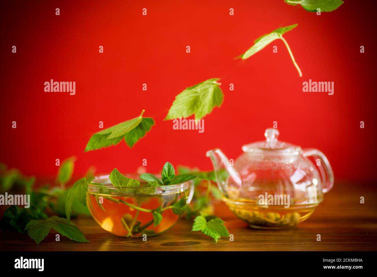 summer refreshing organic tea from currant leaves in a glass teapot ...