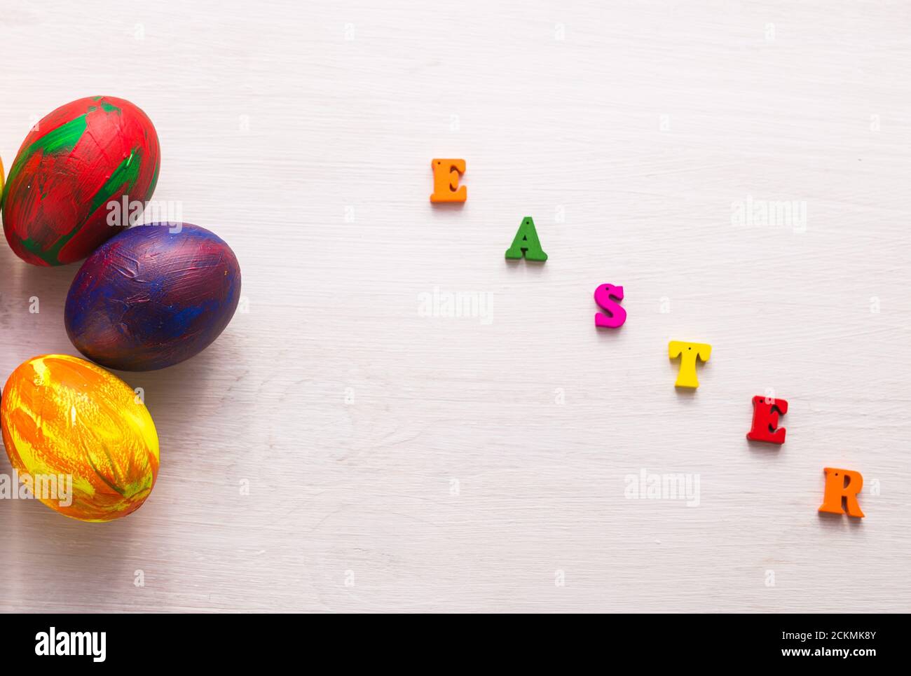 Multi-colored wooden letters making up the words happy easter and ...