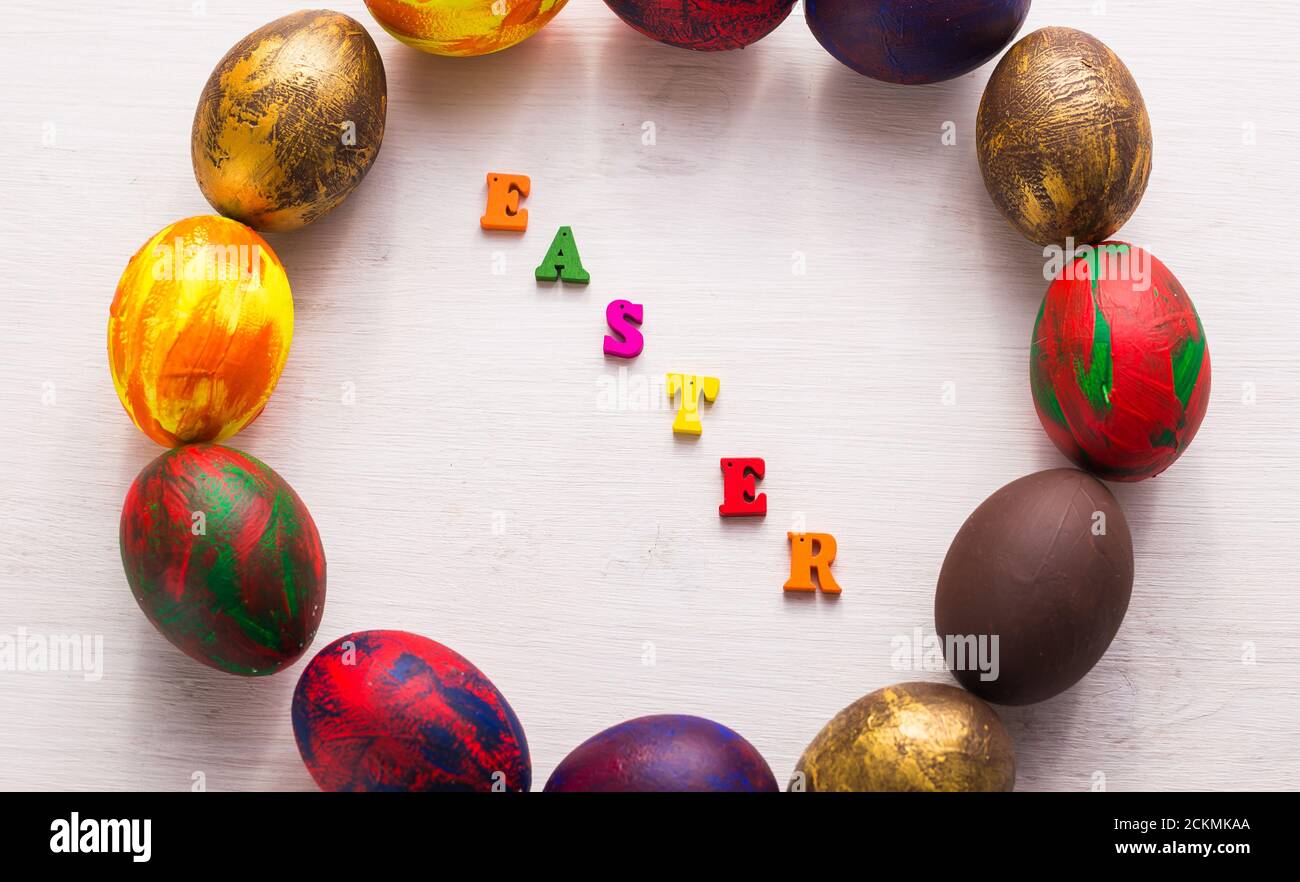 Multi-colored wooden letters making up the words happy easter and ...