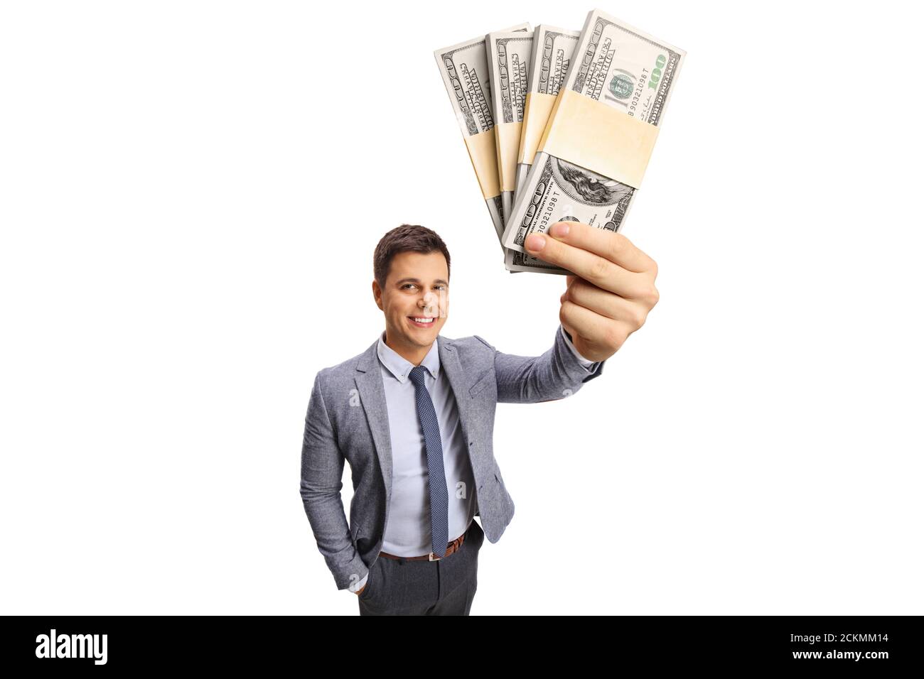 Professional young man showing stacks of money in front of the camera ...