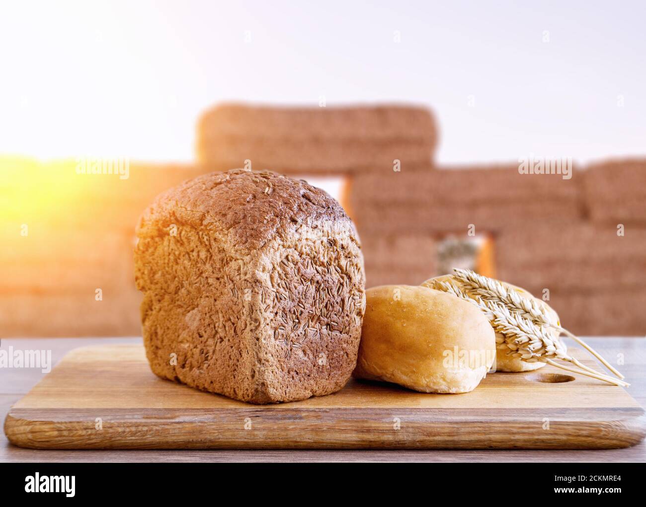 decoration of white flour on brown toast bread and sunset background ...