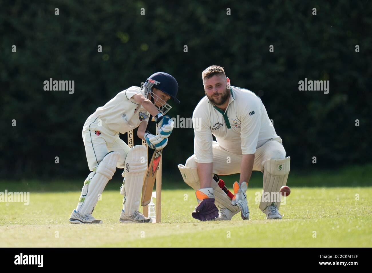 Young boy playing cricket shot during village cricket match for all ...