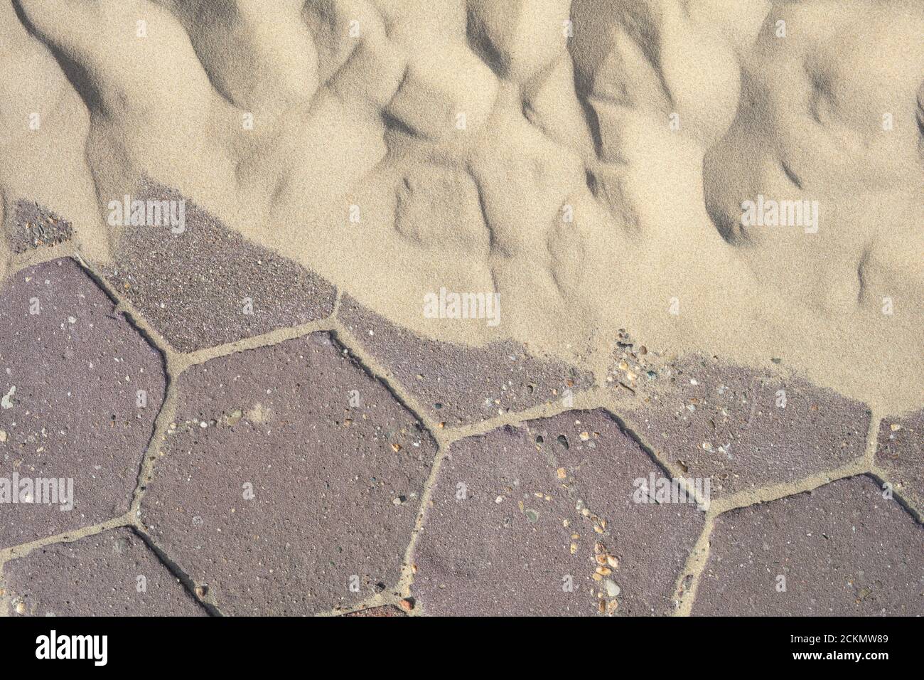 Detail of pavement and sand at the promenade Stock Photo - Alamy