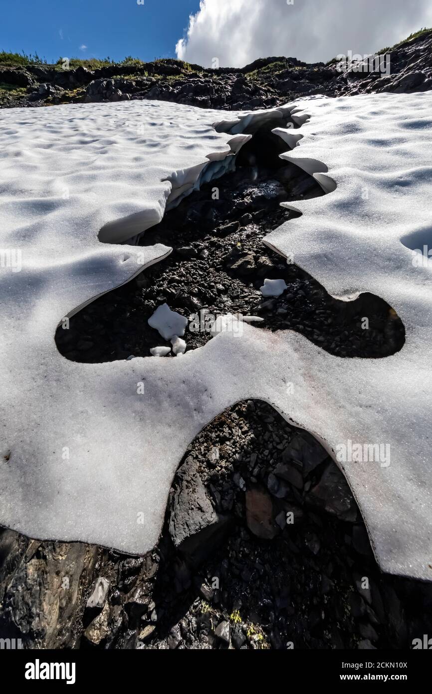 Ceiling collapsed on ice cave, created where stream melts snow under a ...