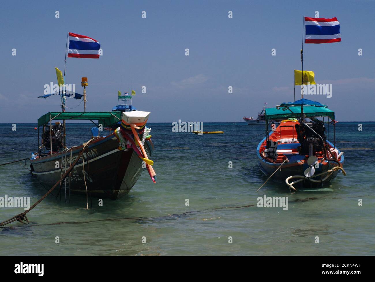 Thai fishing boats with traditional ribbon decoration Stock Photo - Alamy