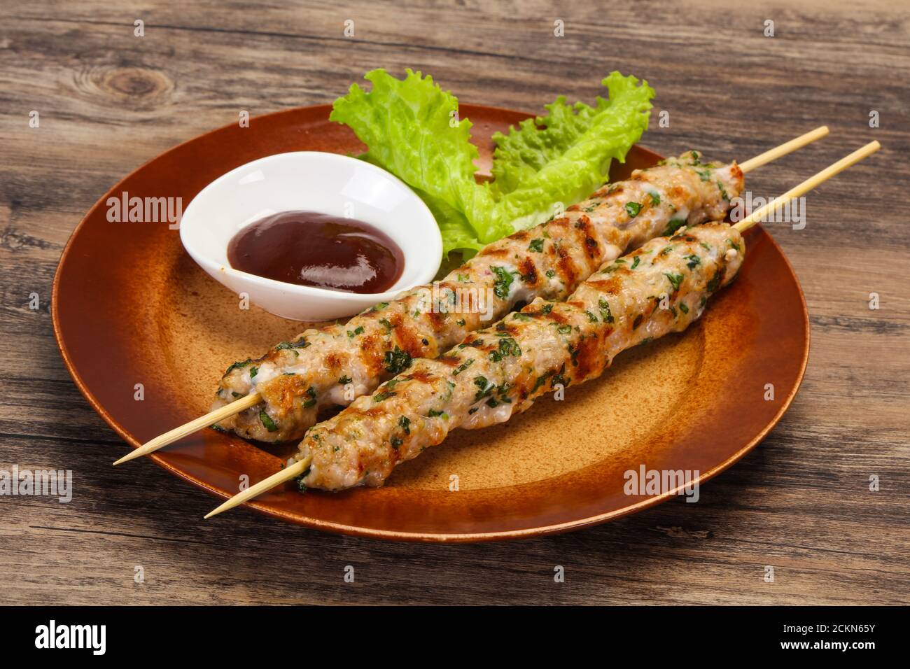 Minced pork skewer kebab with bbq sauce Stock Photo - Alamy