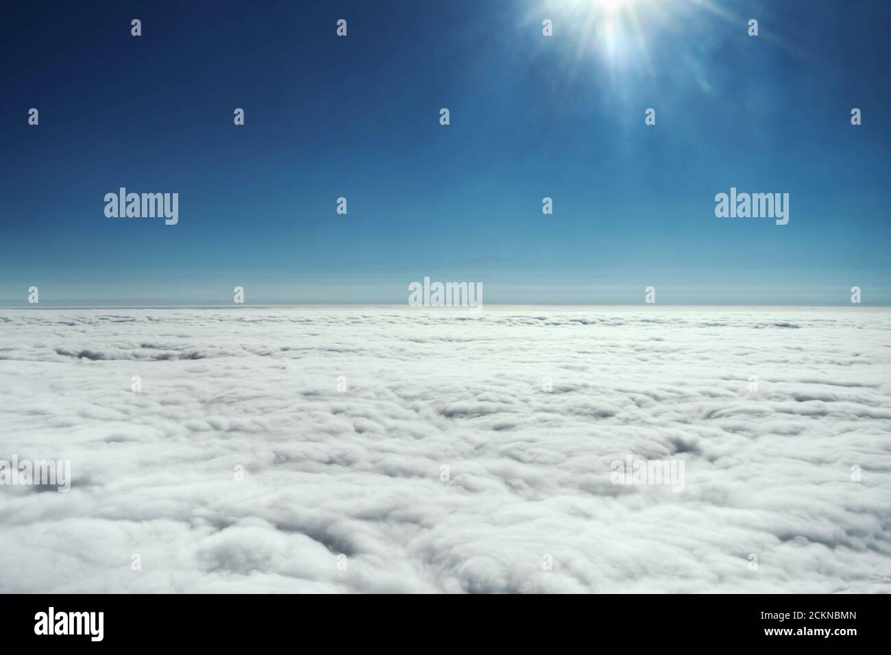 Clear view of the sky with clouds and sun from the plane Stock Photo ...