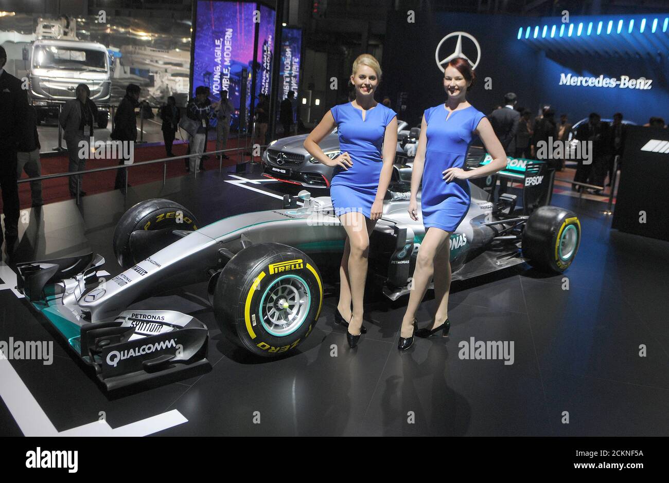 Models pose with a Marcedes Benz racing Concept car at the Auto Expo in ...