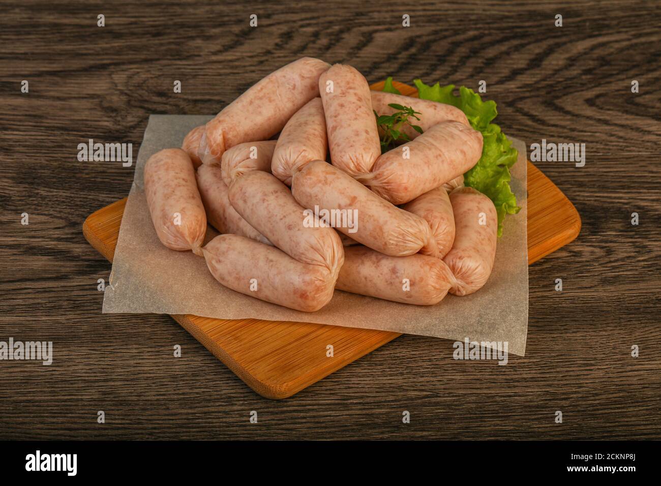 Raw natural chicken baby sausages for roast Stock Photo - Alamy