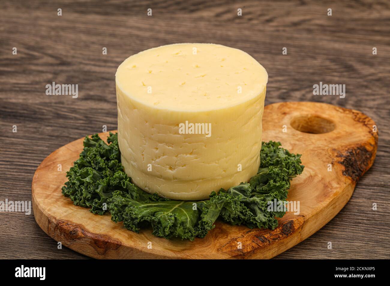Yellow round dairy soft cheese piece Stock Photo - Alamy