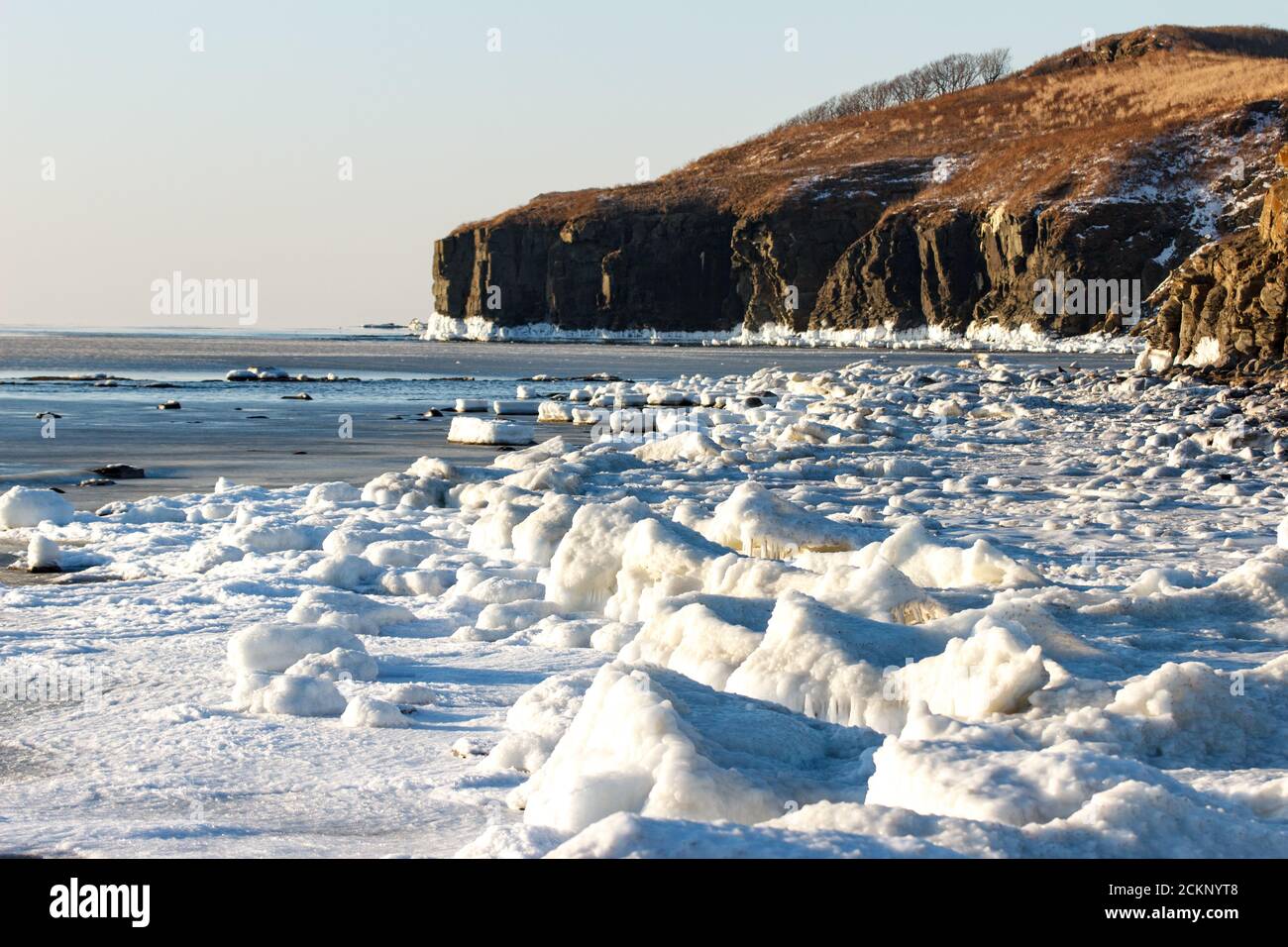 Ice floes floating in the winter sea off the snow-covered coast of Cape ...