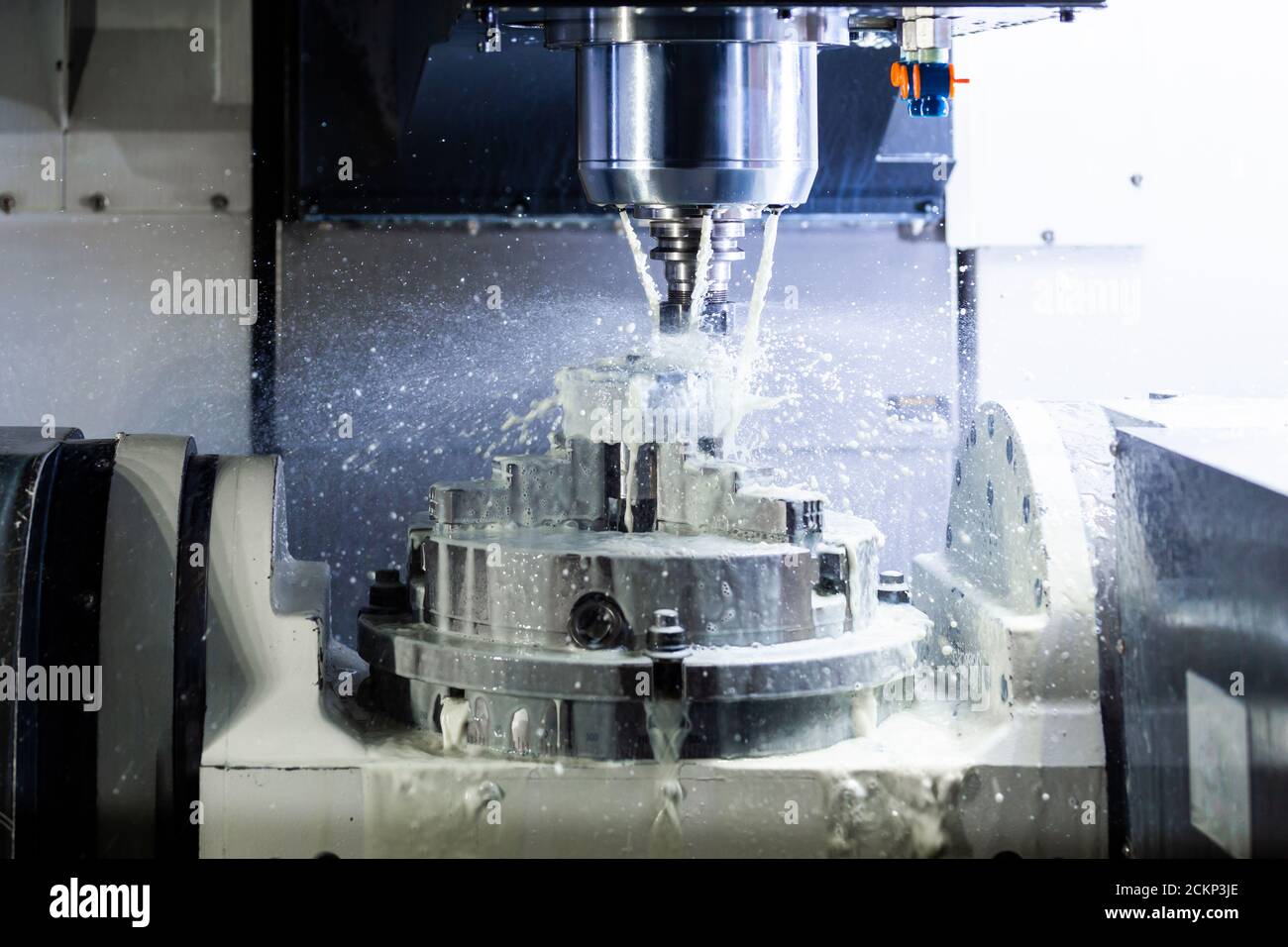 a process of industrial wet milling in 5-axis cnc machine with coolant ...
