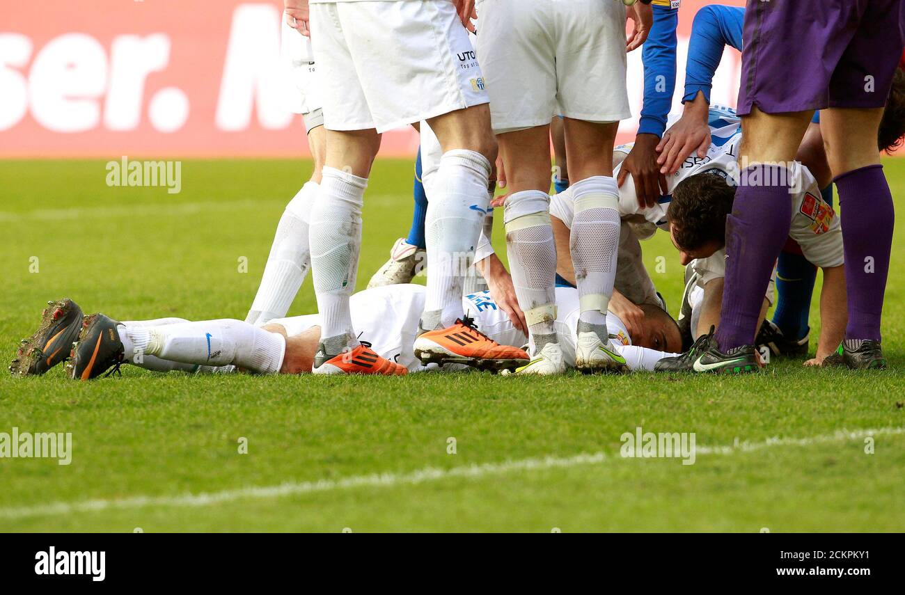 Lies injured on pitch after hi-res stock photography and images - Alamy