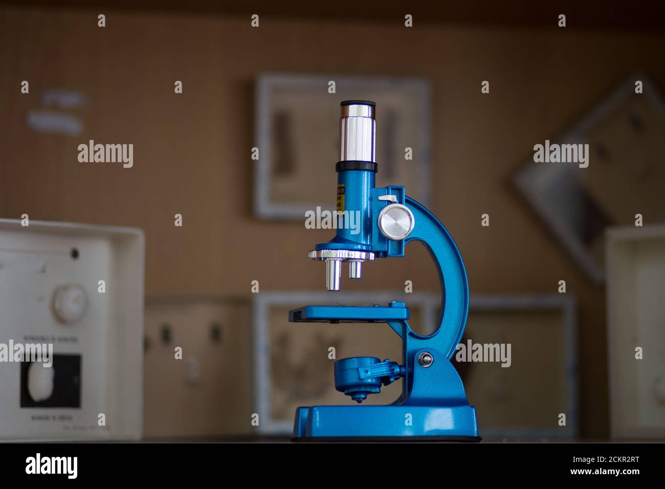 blue microscope stands on a shelf of a training cabinet Stock Photo - Alamy