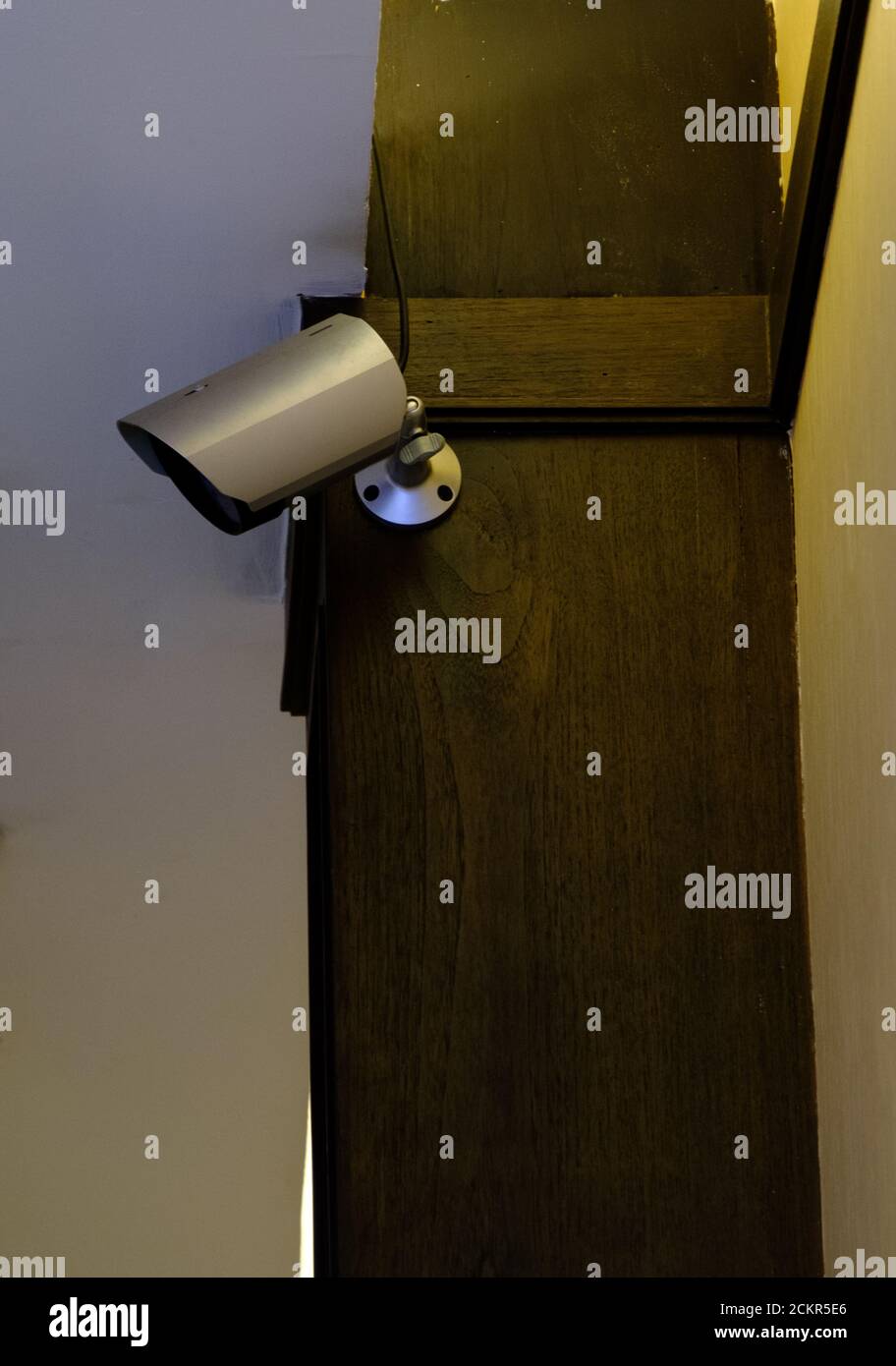Small modern CCTV is installed on the wooden pillar for security in the ...