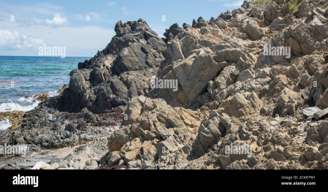 Coastal rock at Jack Bay with turquoise Caribbean Sea waters on St ...