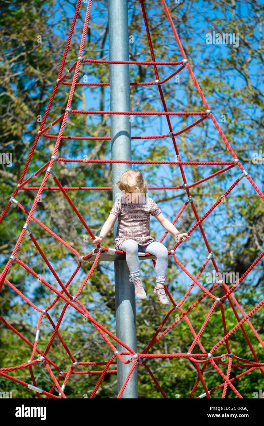 girl climbing up on a playground Stock Photo - Alamy