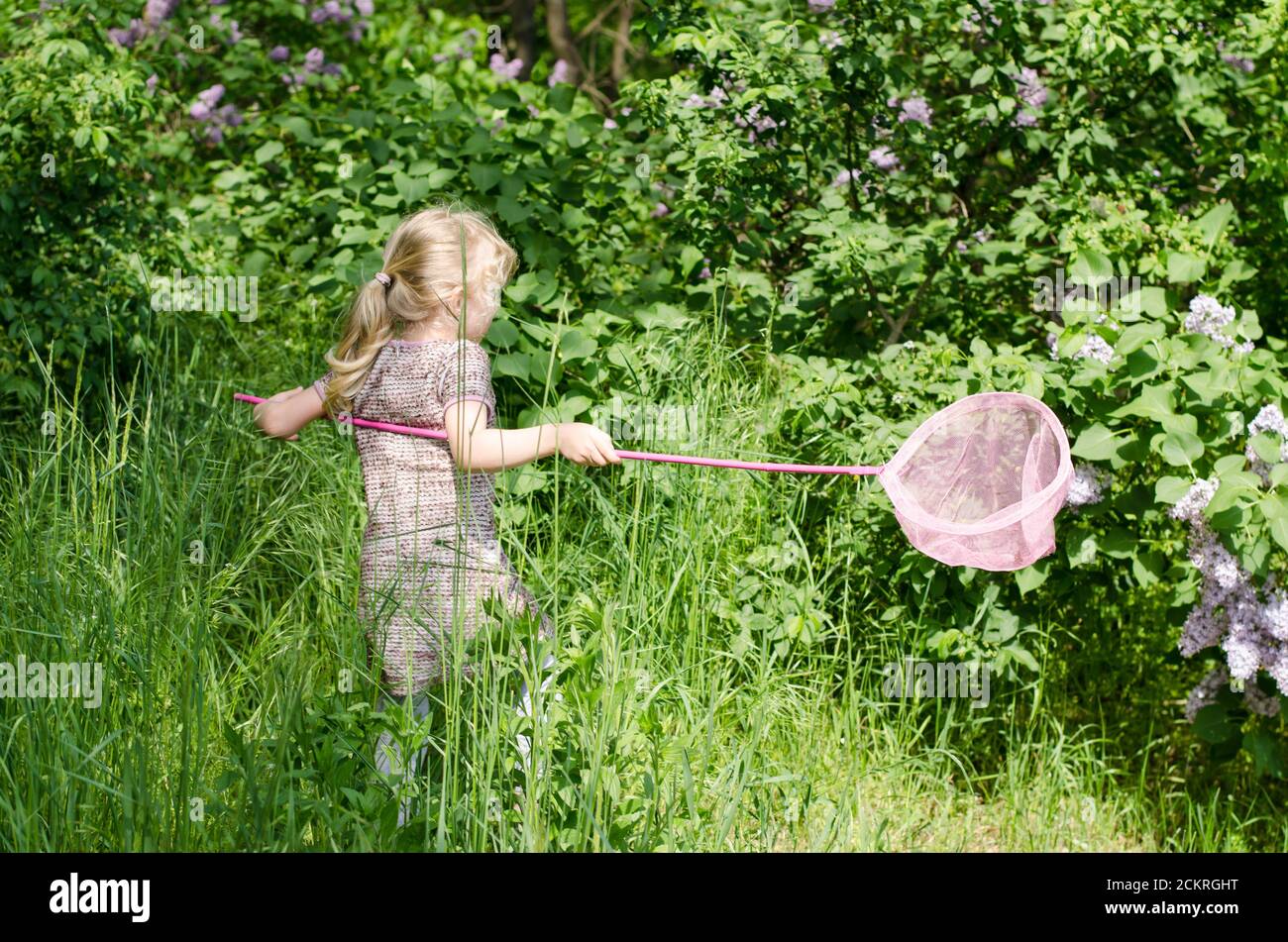Girl catching butterflies hi-res stock photography and images - Alamy