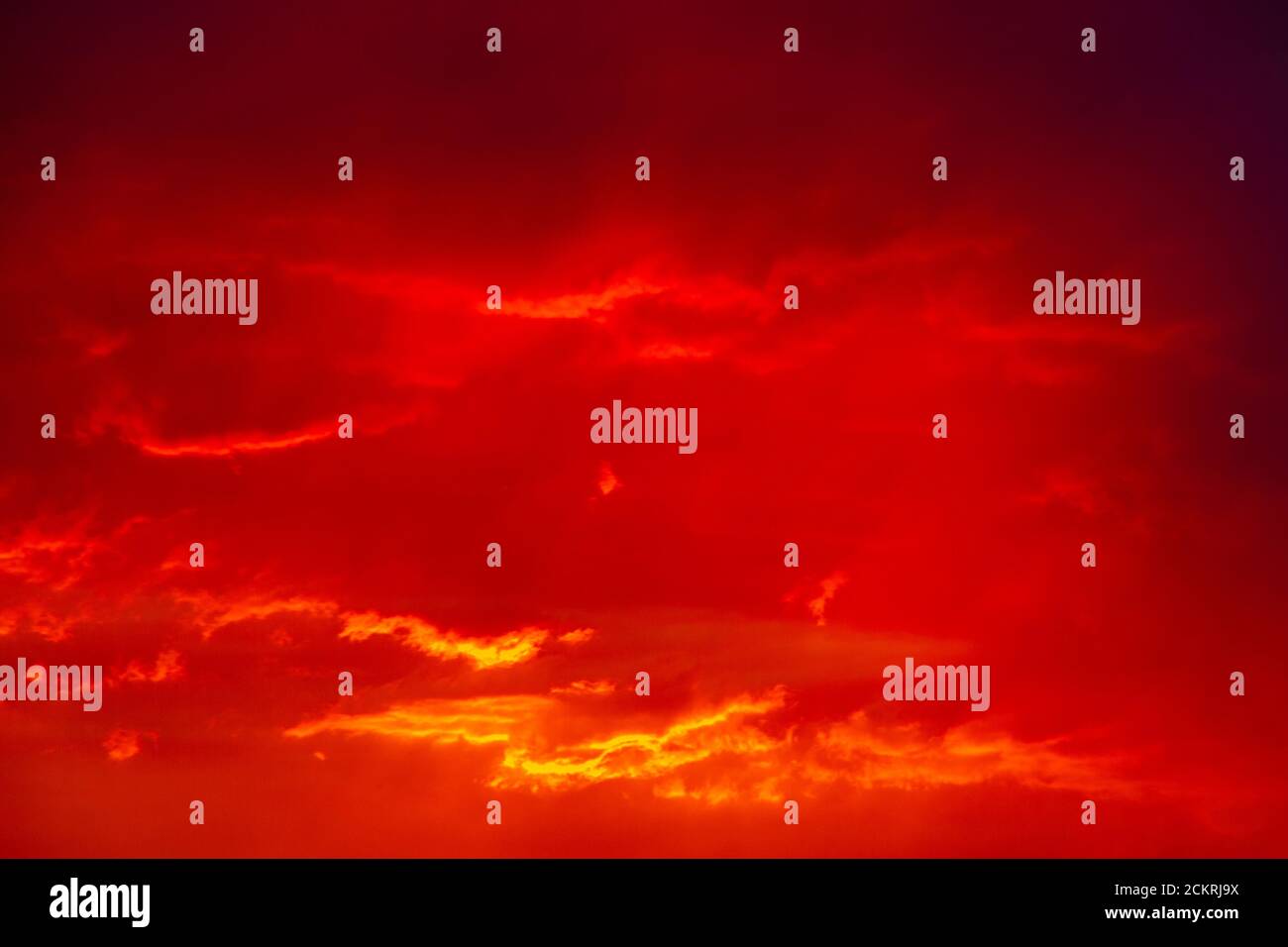 Red cloudy sky reflection the last rays of a sunset Stock Photo - Alamy