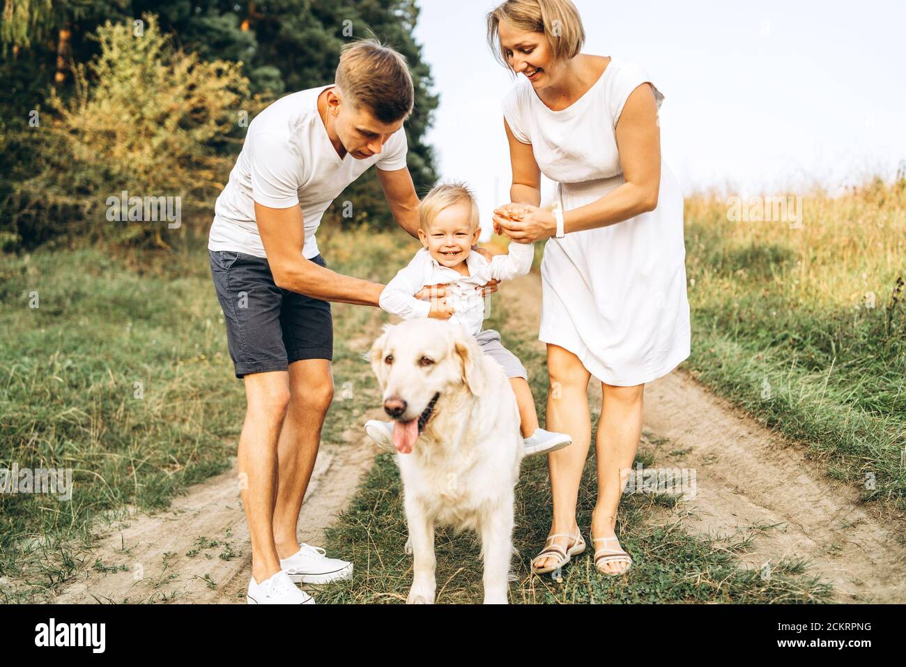 Happy young family with dog have fun outdoor Stock Photo - Alamy