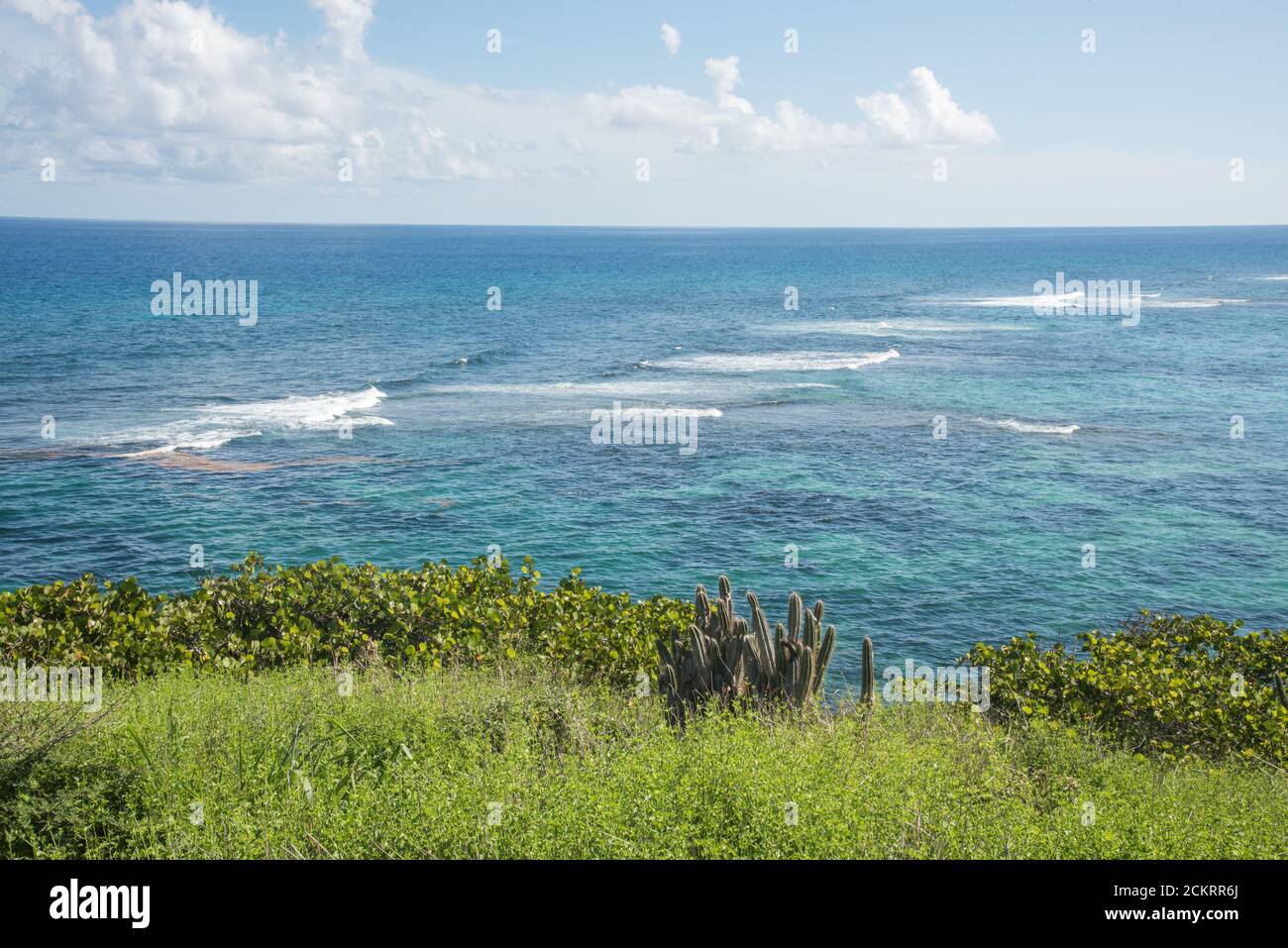 Elevated view over the stunning Caribbean Sea flowing with native ...