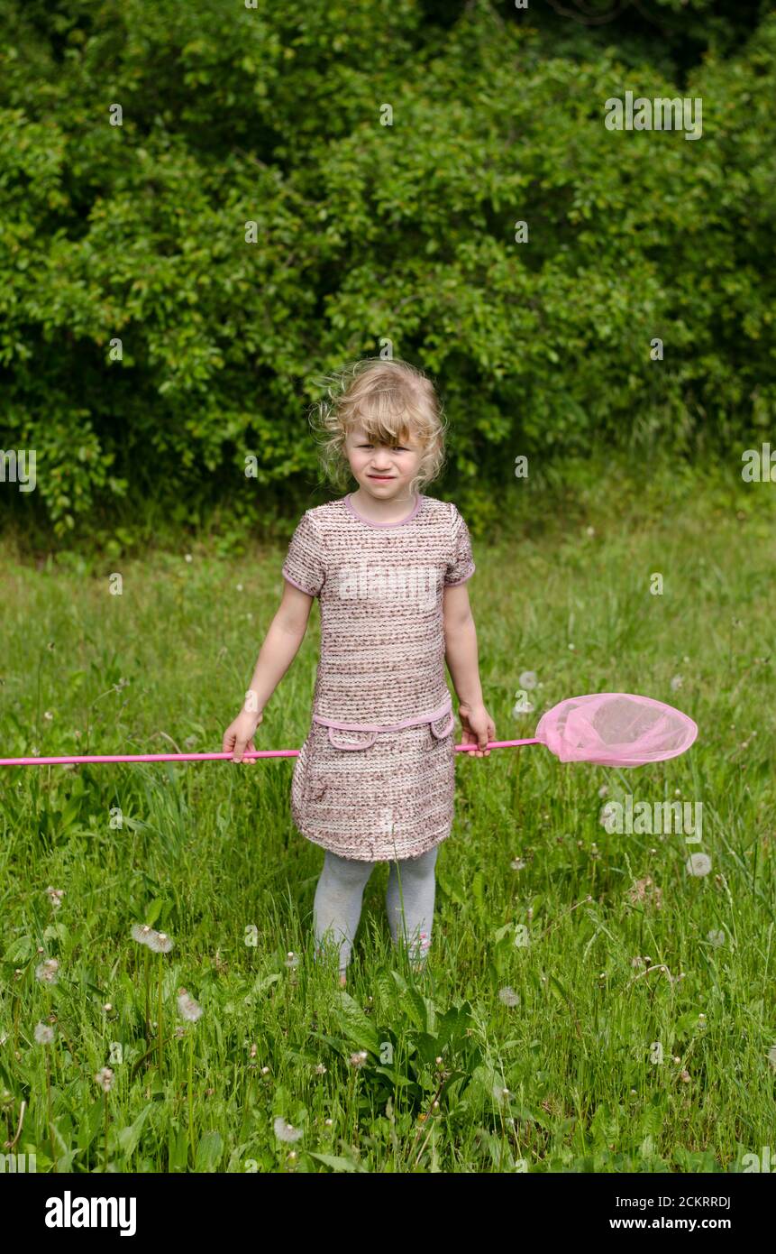 girl on the meadow catching butterflies Stock Photo - Alamy