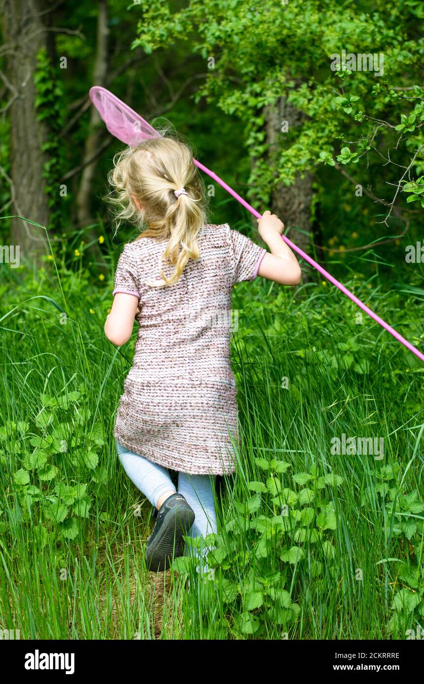 girl on the meadow catching butterflies Stock Photo - Alamy