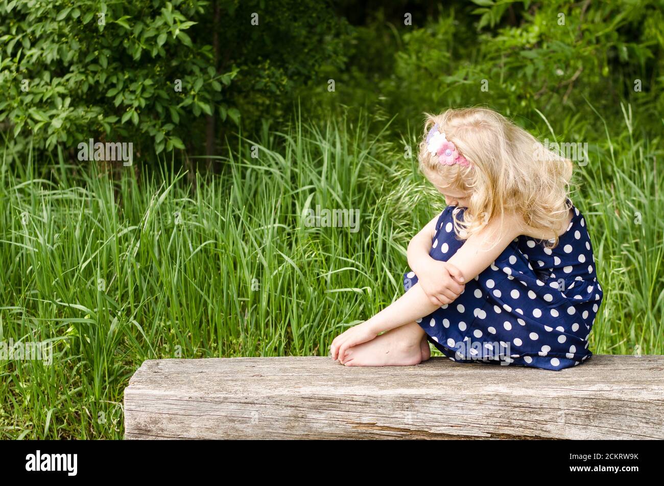 Sad girl sitting grass hi-res stock photography and images - Alamy
