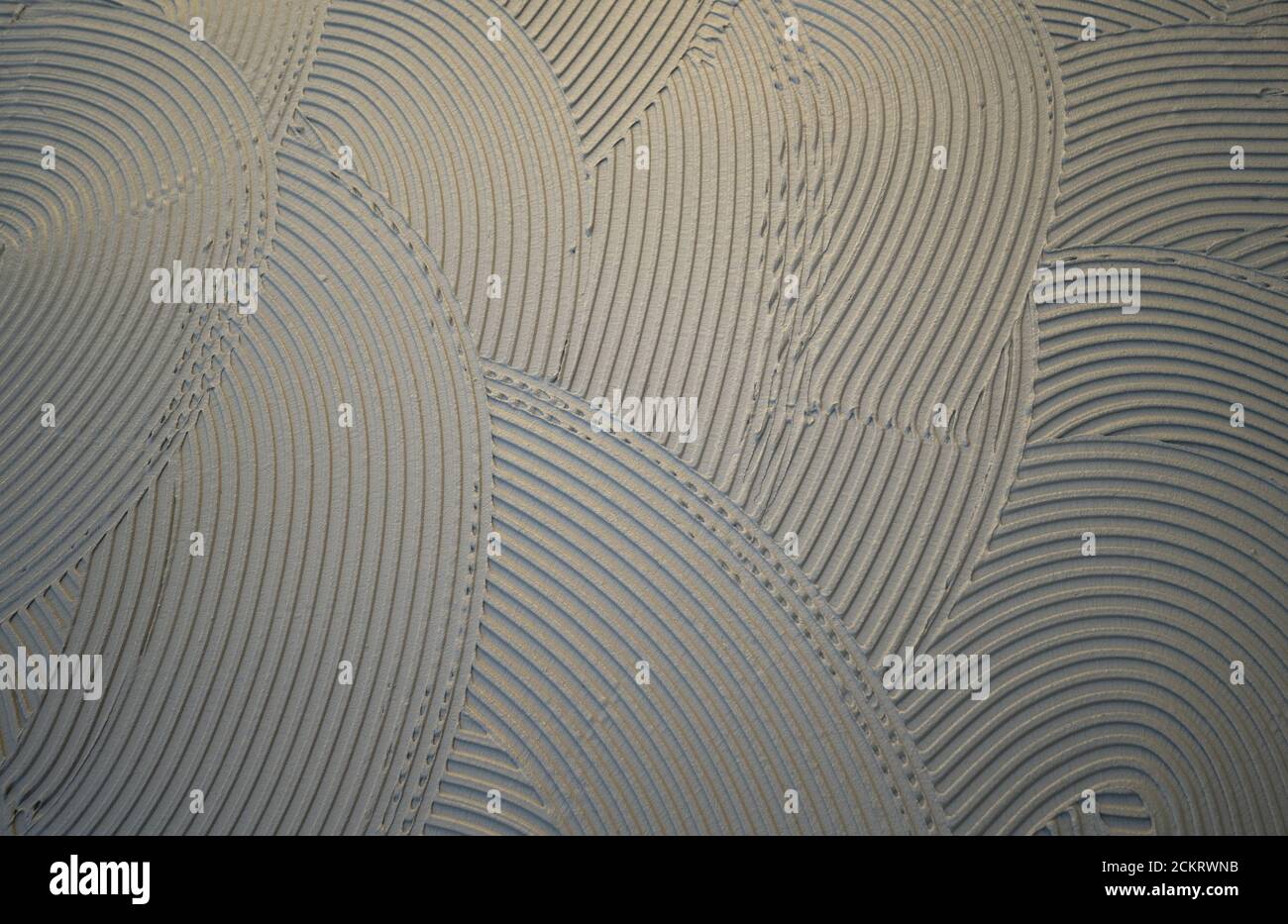 cementitious adhesive applied to the floor ready to receive the ceramic ...