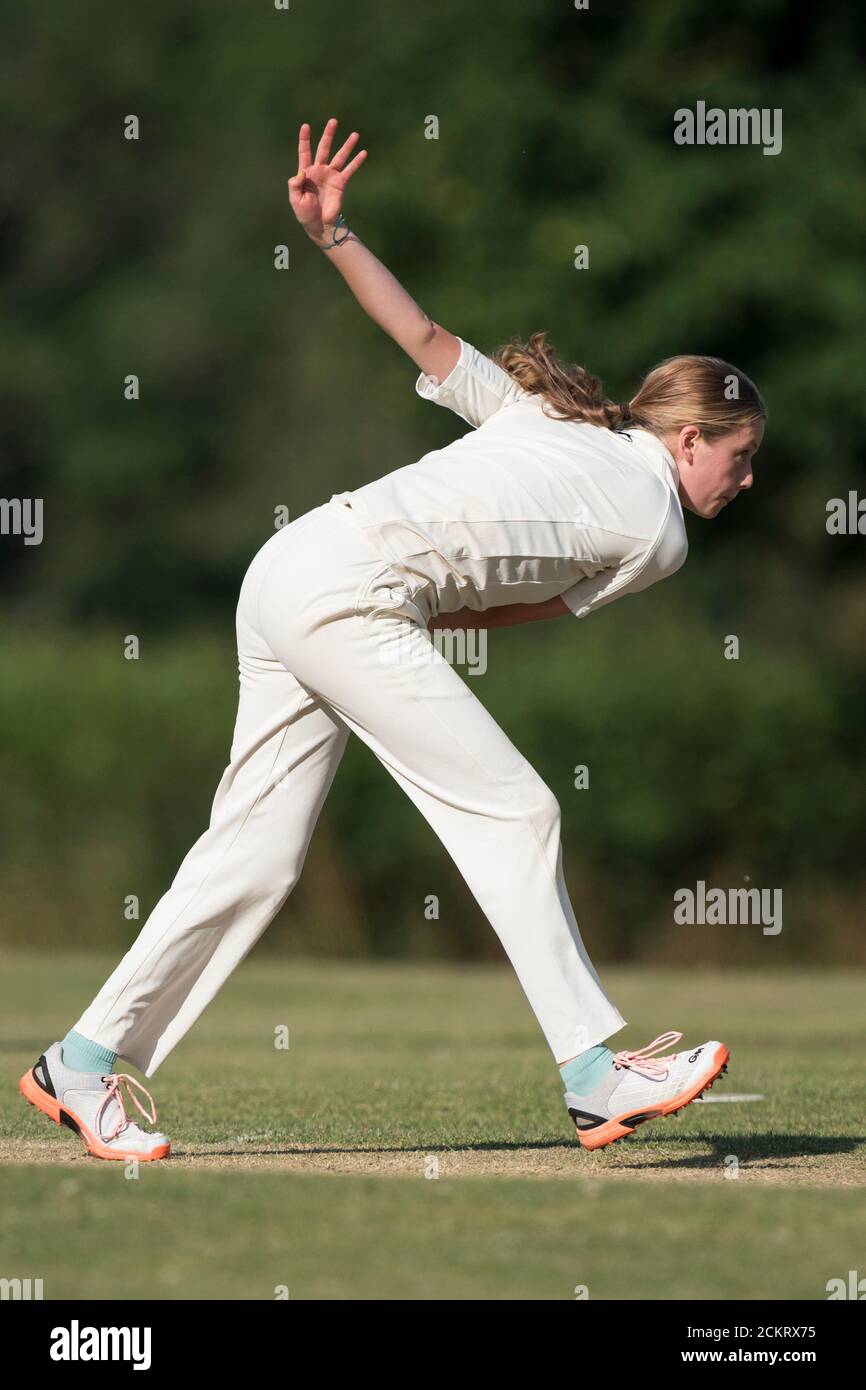 Female cricket player bowling, Dorset, England Stock Photo - Alamy