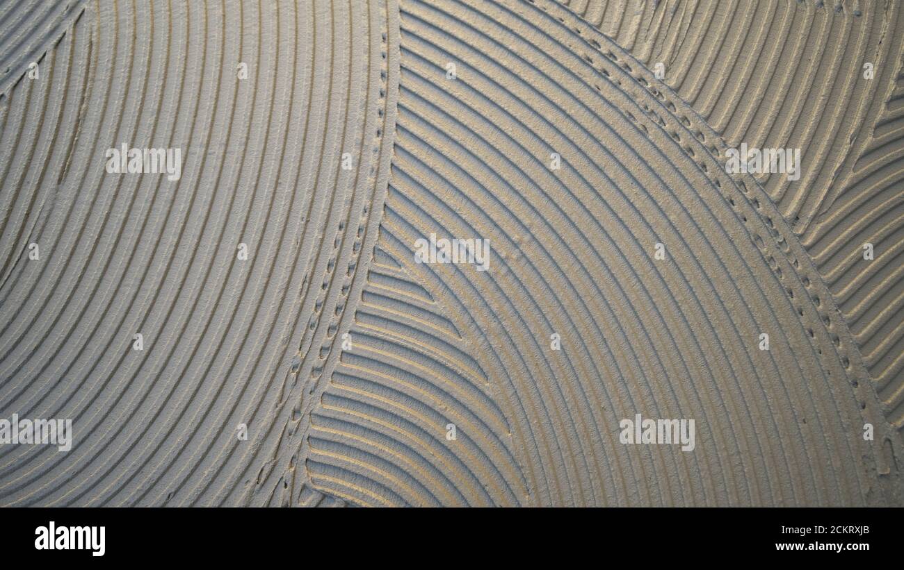 cementitious adhesive applied to the floor ready to receive the ceramic ...