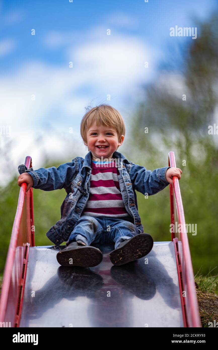 happy young boy on a slide Stock Photo - Alamy