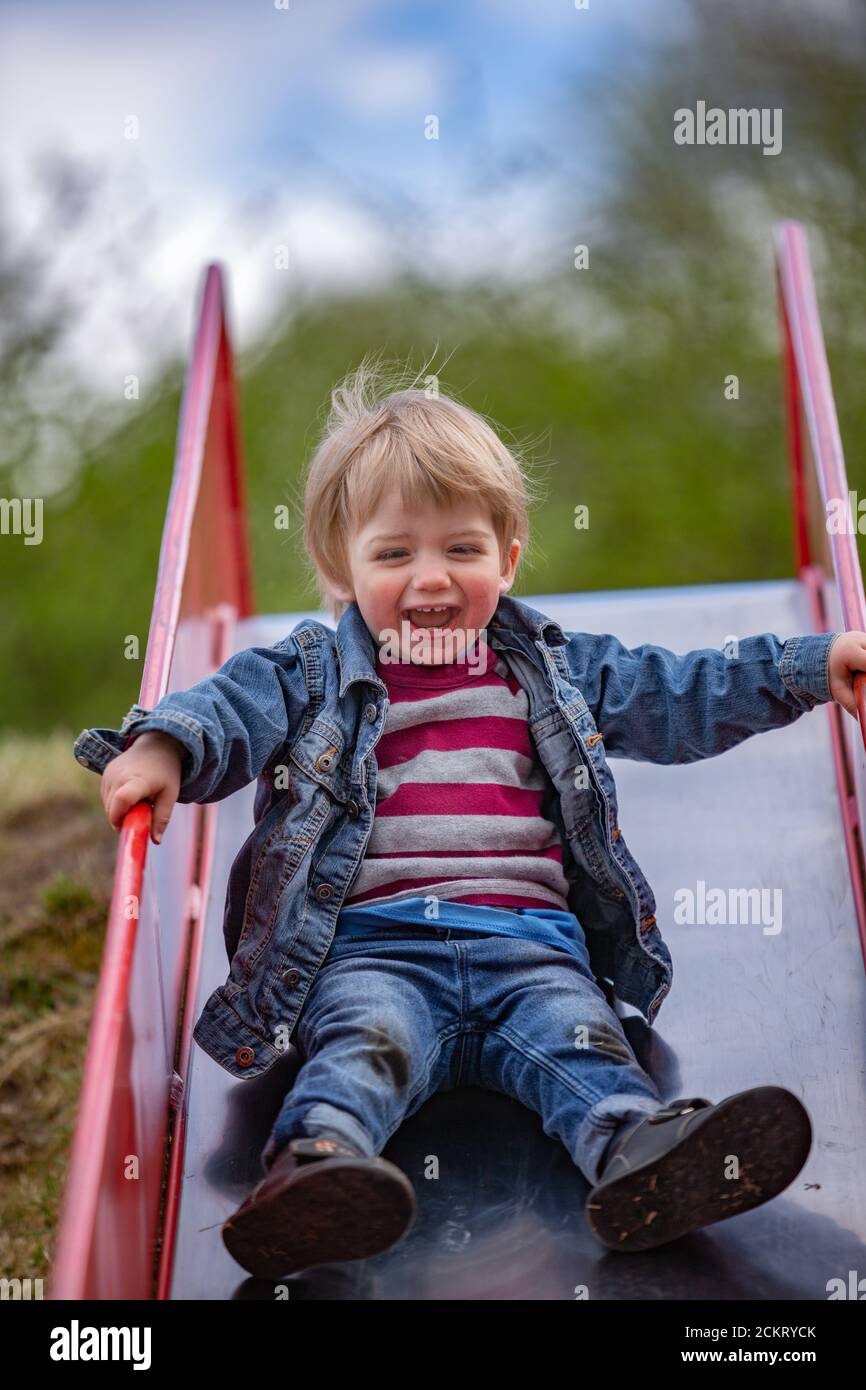 happy small boy on a slide Stock Photo - Alamy