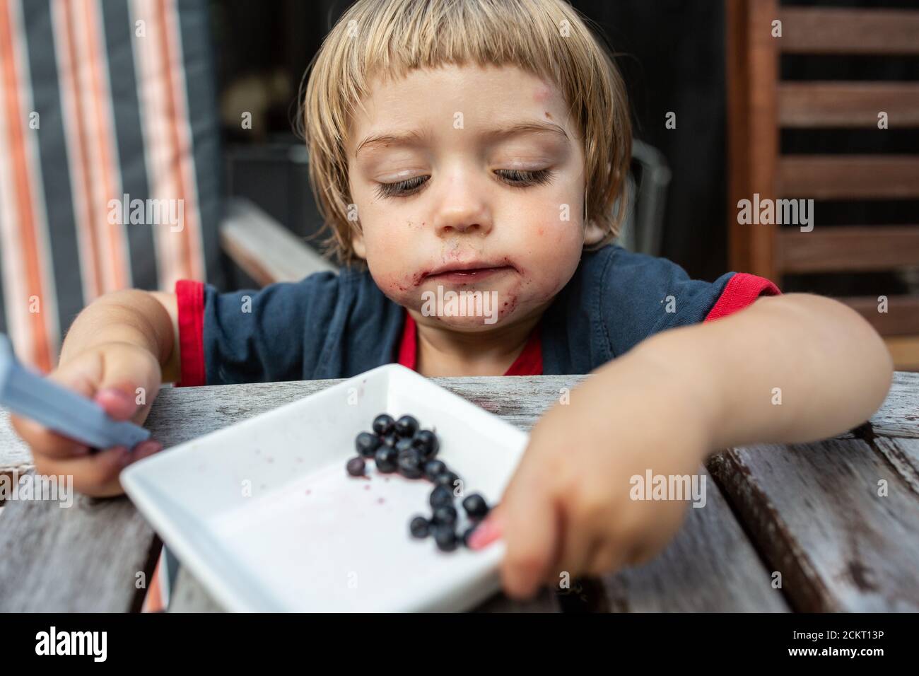 Kid tasting berries hi-res stock photography and images - Alamy
