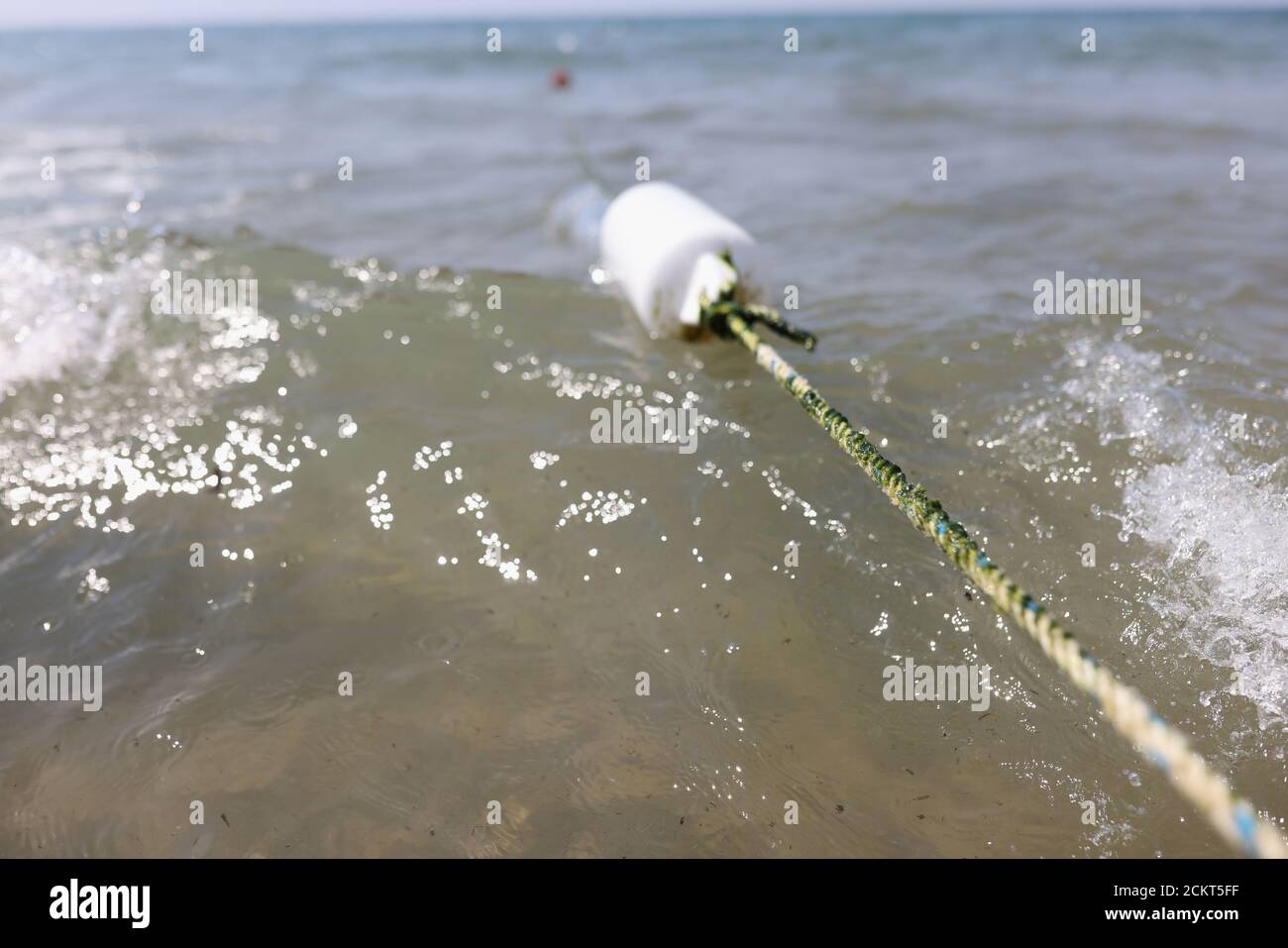 Rope fence in ocean for swimming area Stock Photo - Alamy