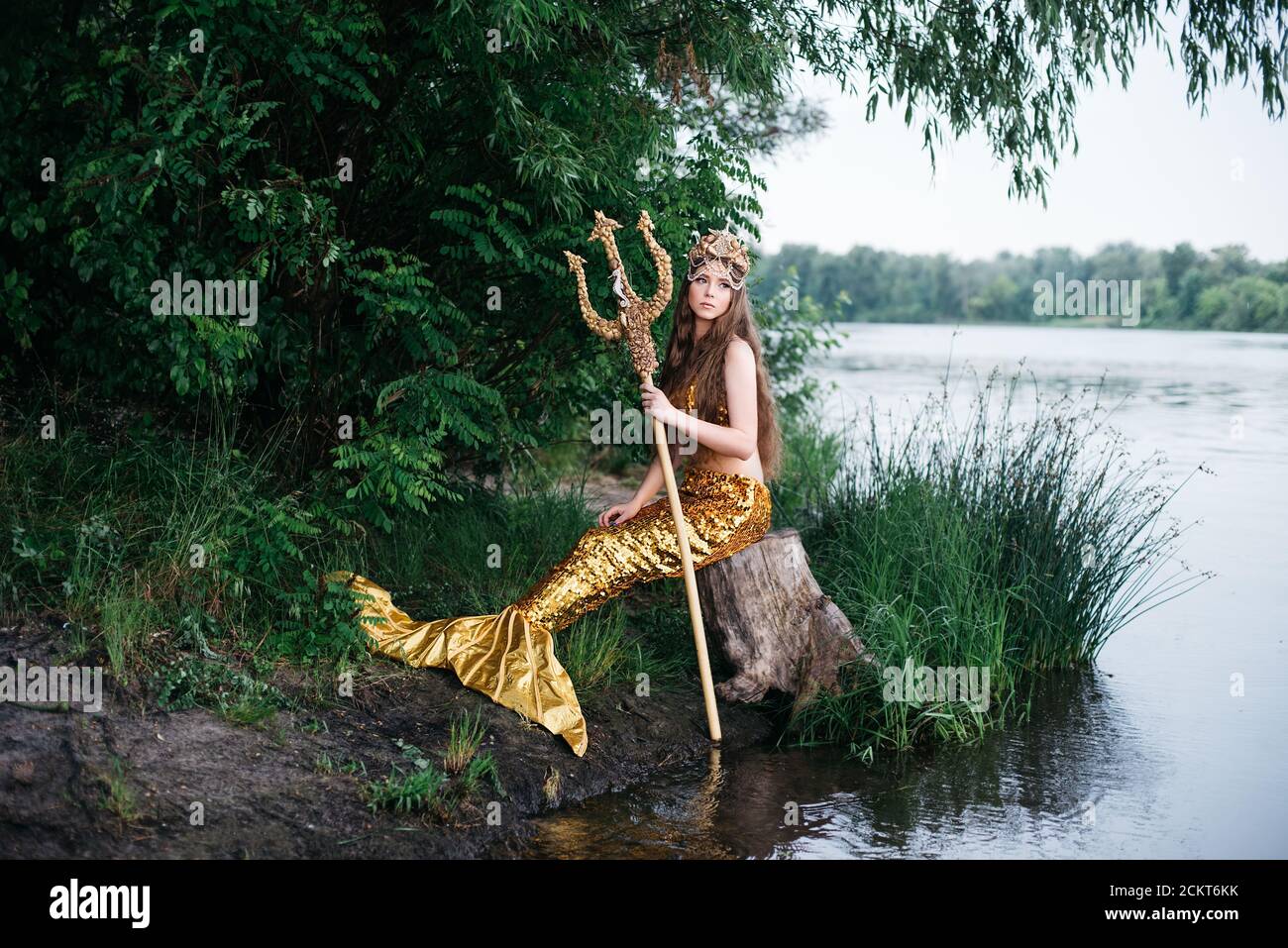 Fantasy woman real mermaid with trident myth goddess of sea with golden ...