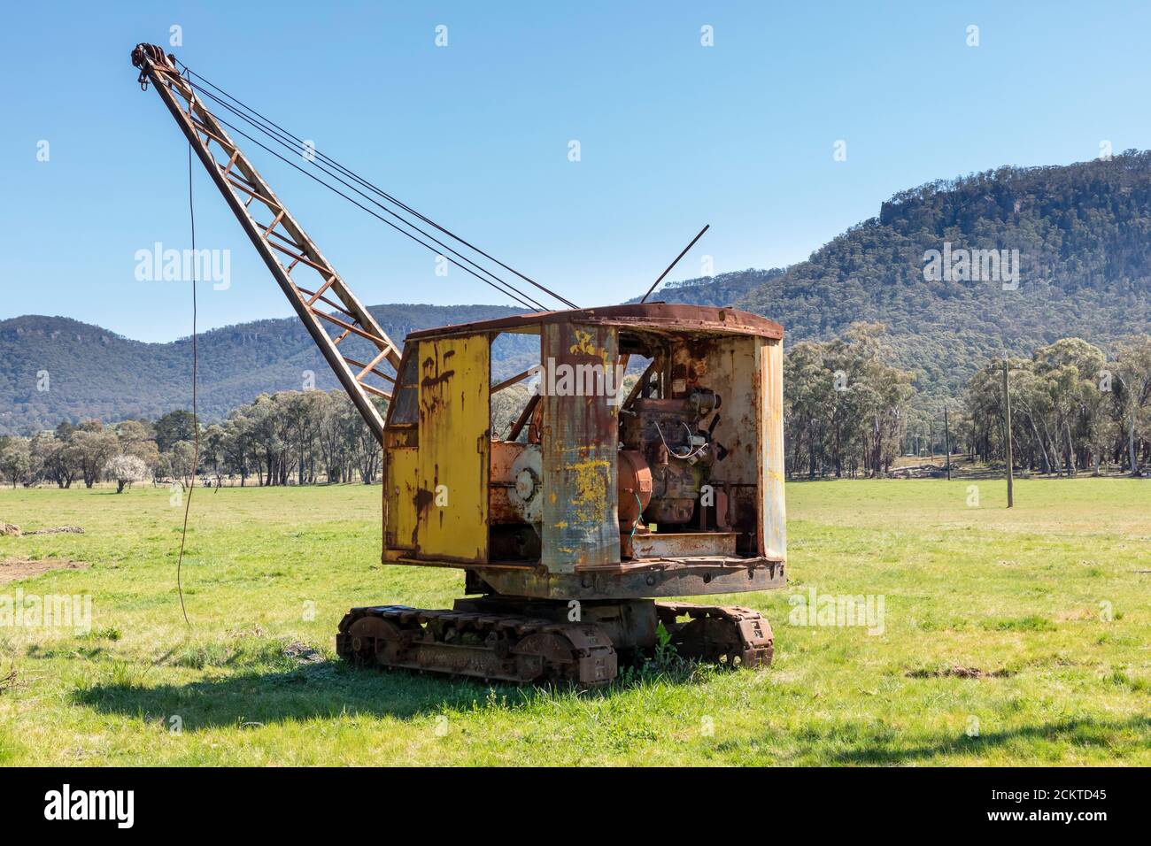 An old rusty crane in a green field in regional Australia Stock Photo ...
