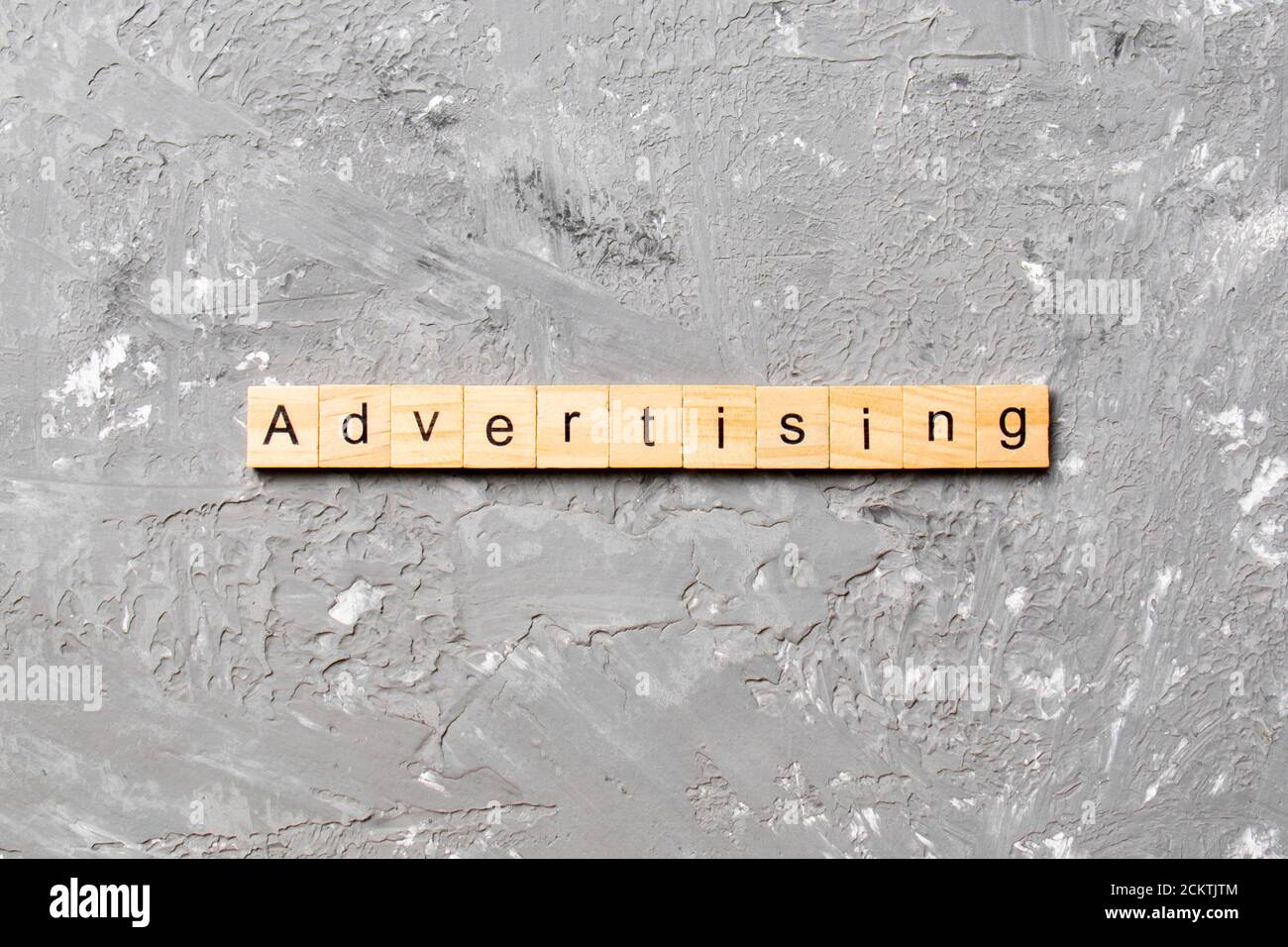 ADVERTISING word written on wood block. ADVERTISING text on cement ...