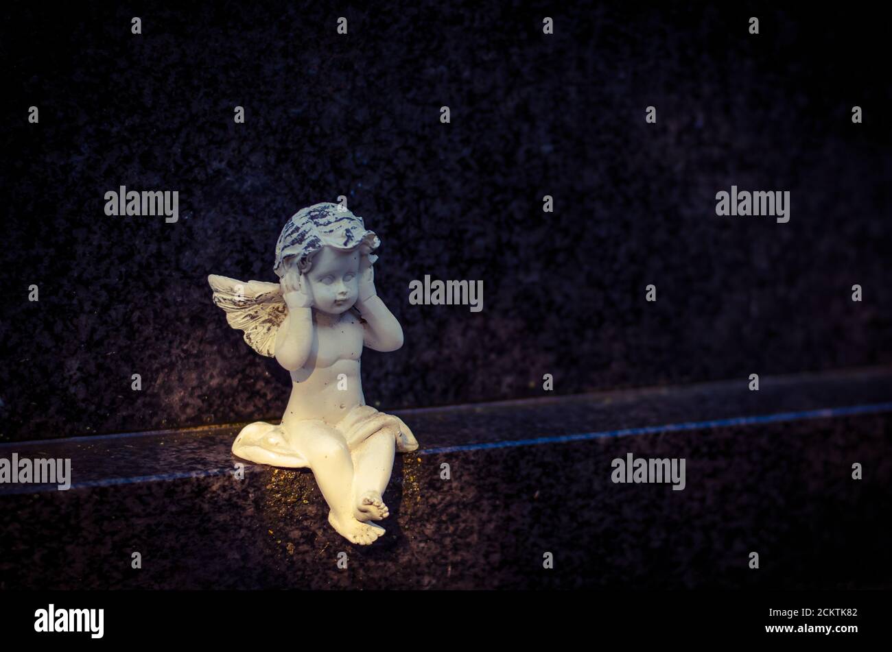 angel sitting on black grave copy space Stock Photo - Alamy