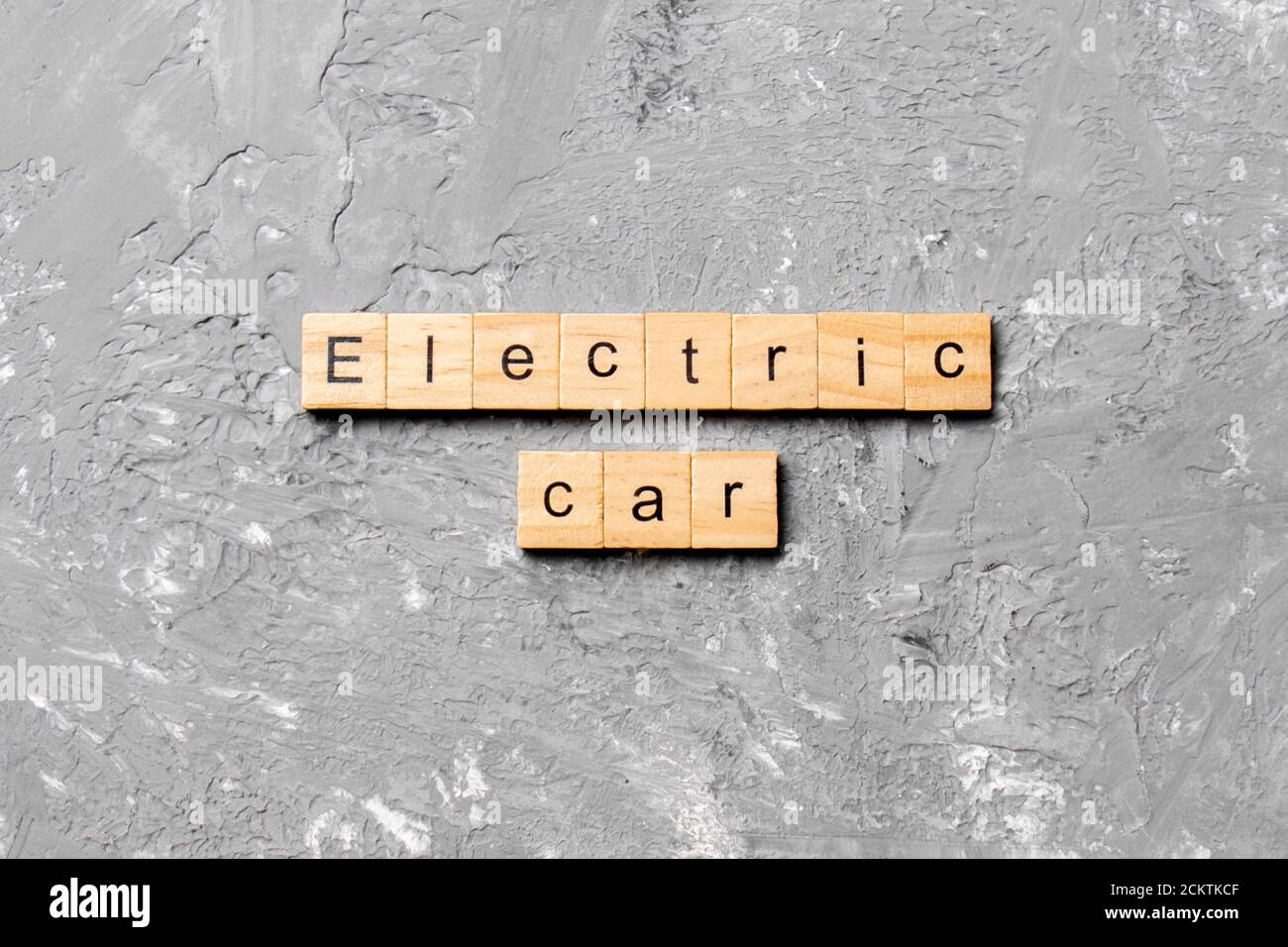 Electric Car word written on wood block. Electric Car text on cement ...