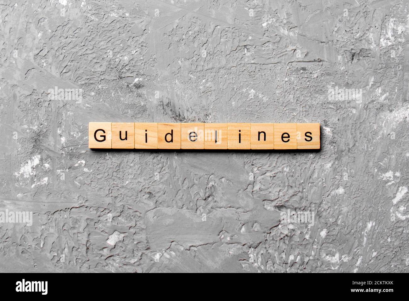 Guidelines word written on wood block. Guidelines text on table ...