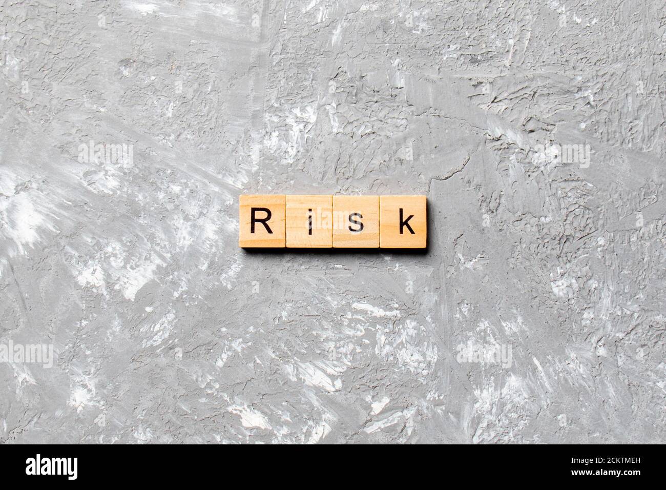 Risk word written on wood block. Risk text on cement table for your ...
