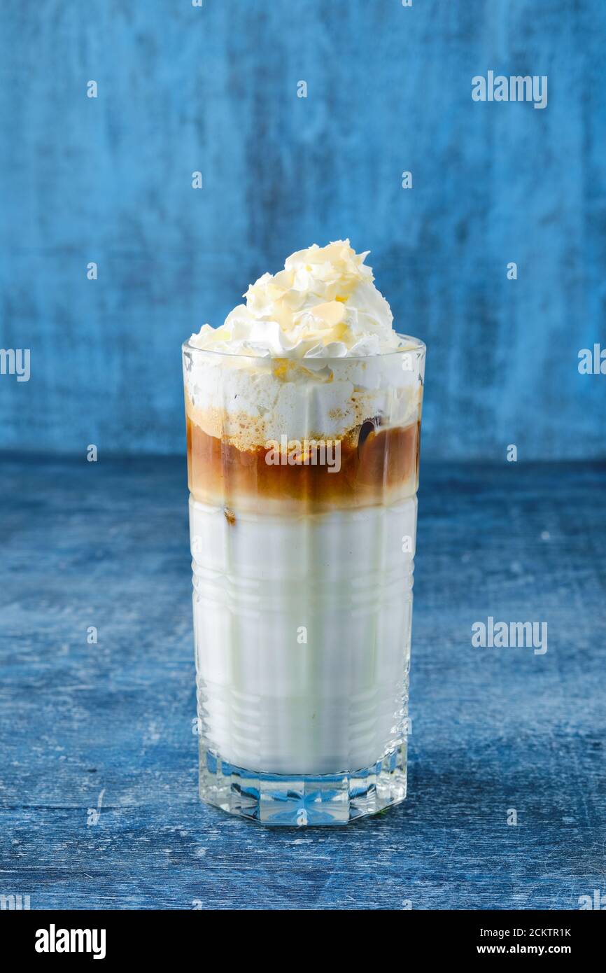 Tall glass of milkshake with whipped cream and peanut flakes Stock ...