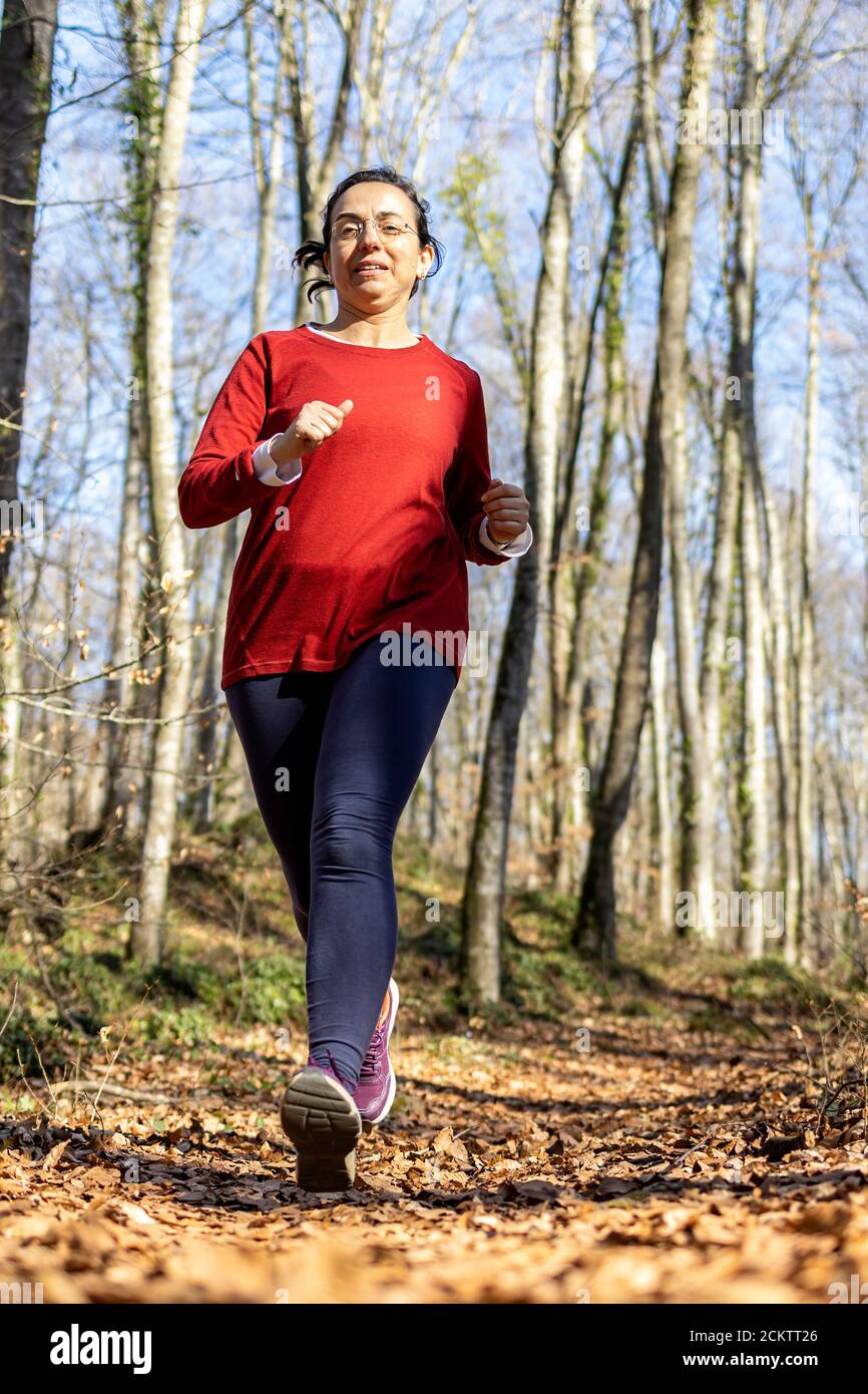 Girl enjoying jog in forest hi-res stock photography and images - Alamy