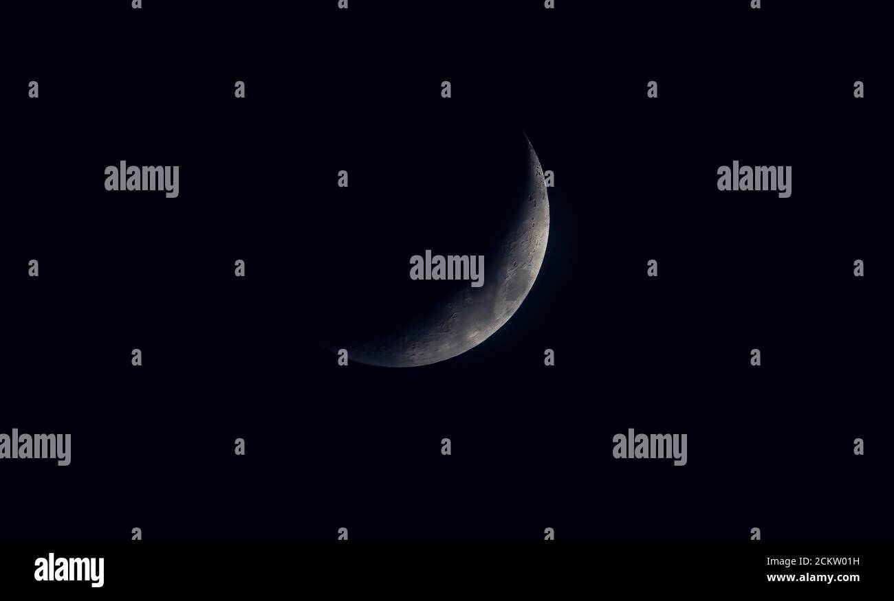 Sickle shaped moon on the night sky Stock Photo - Alamy
