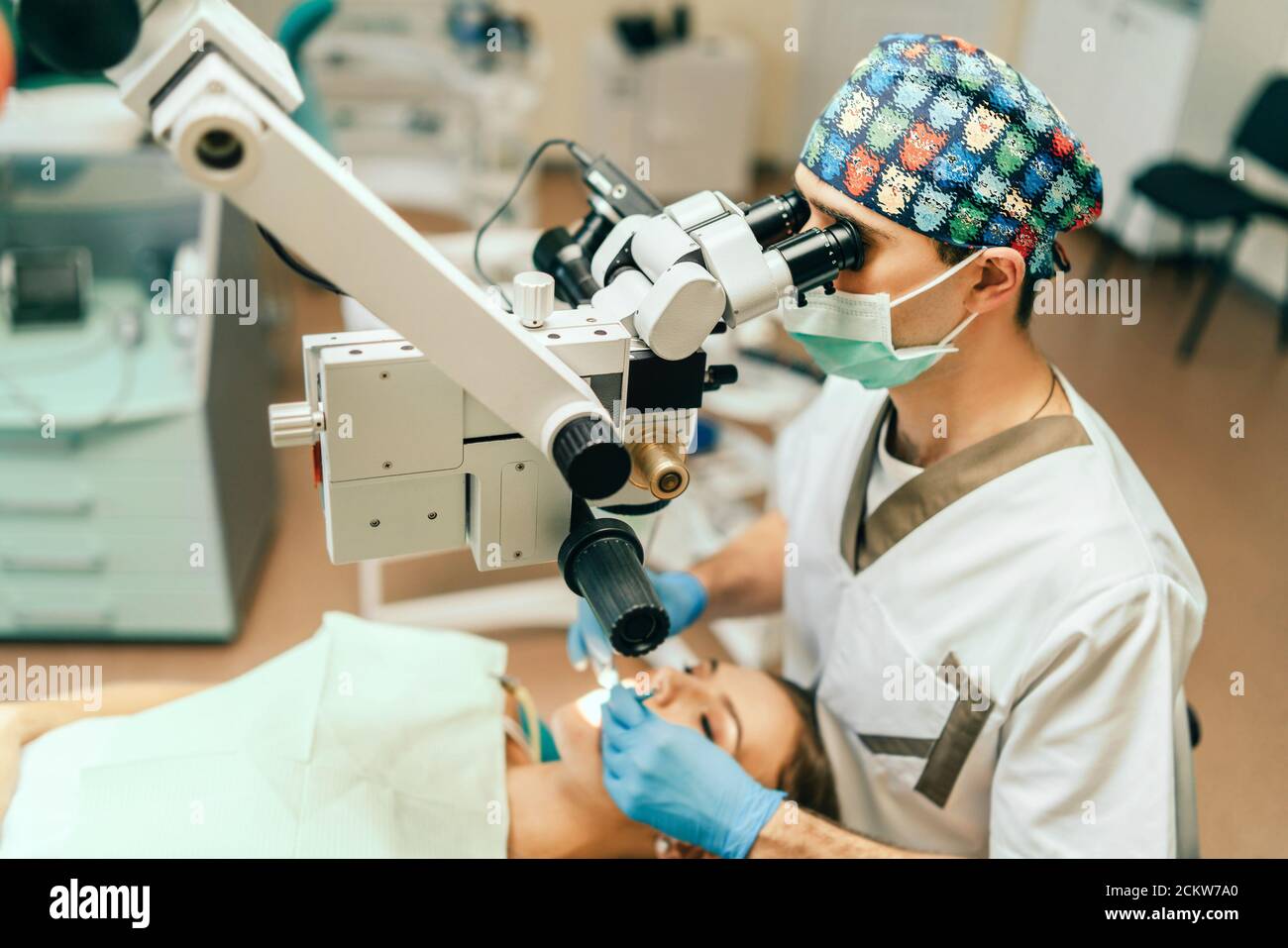 Dentist examine oral cavity of female patient with microscope Stock ...