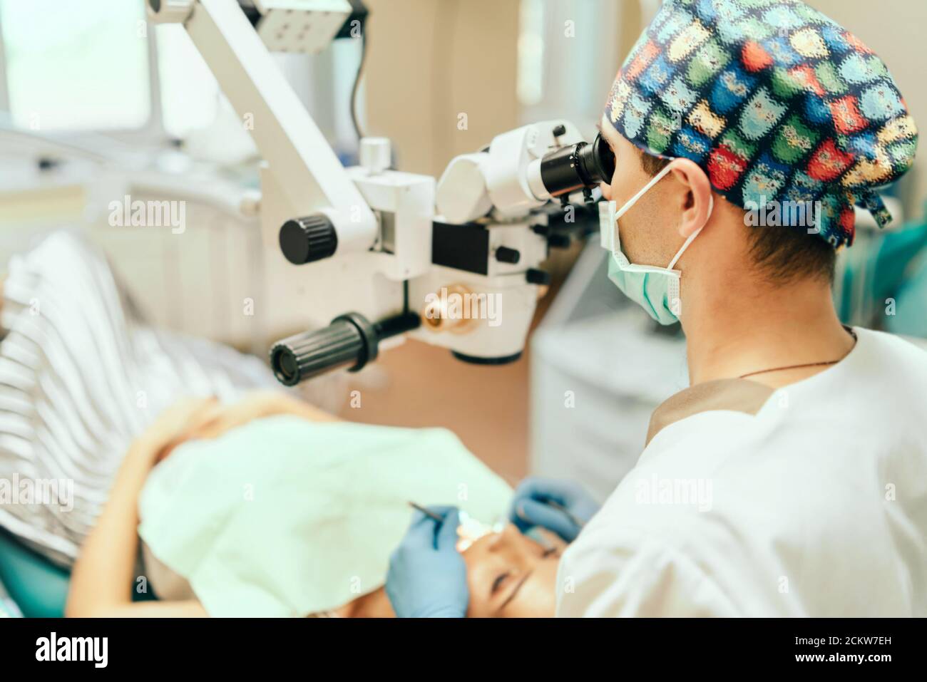 Dentist examine oral cavity of female patient with microscope Stock ...