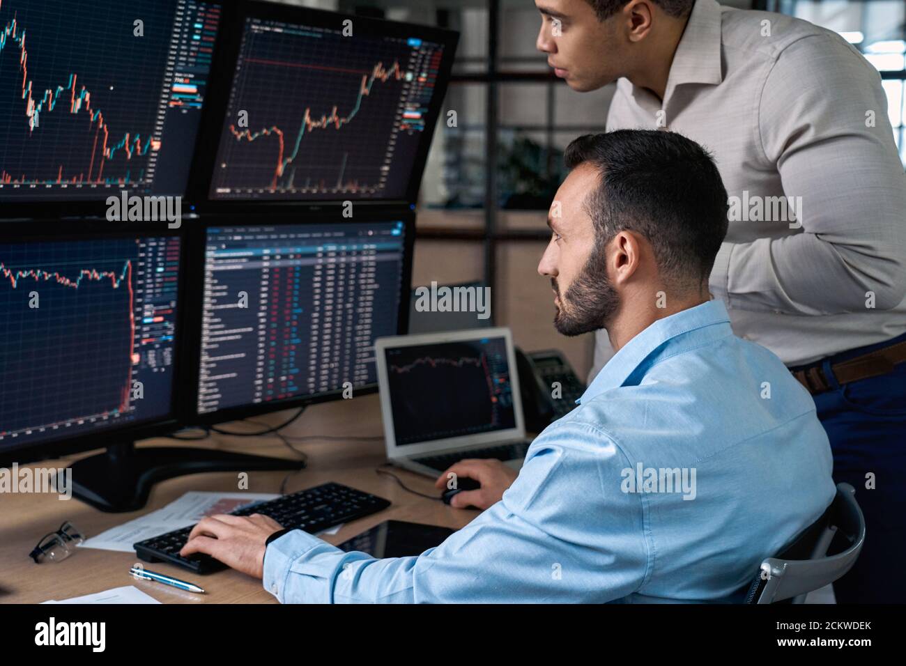 Two stock broker analyzing index on cryptocurrency diagram Stock Photo ...